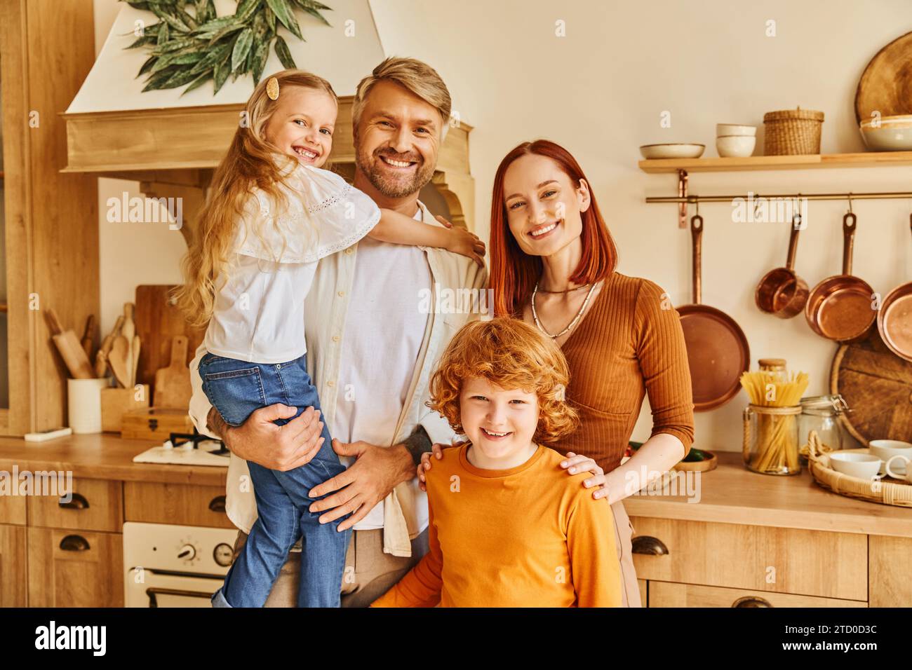 joyful children with smiling parents looking at camera in modern ...
