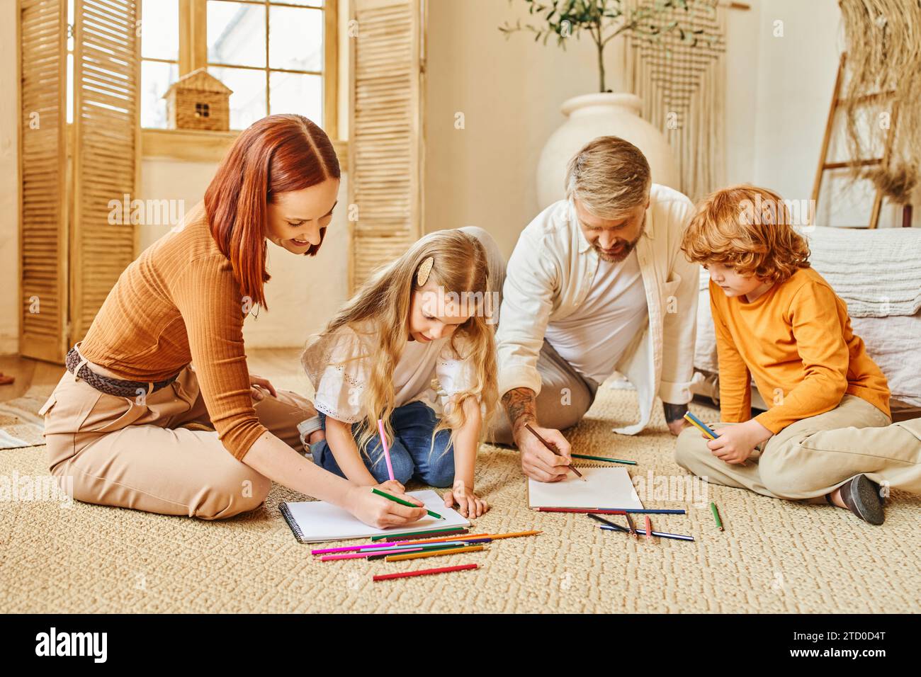 joyful parents and children drawing together on floor in modern living ...