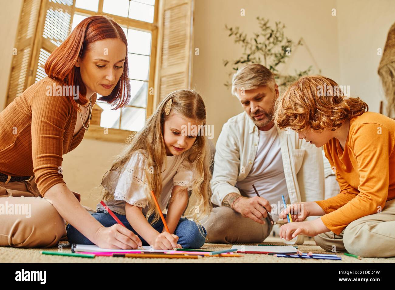 happy children drawing together with parents on floor in cozy living ...