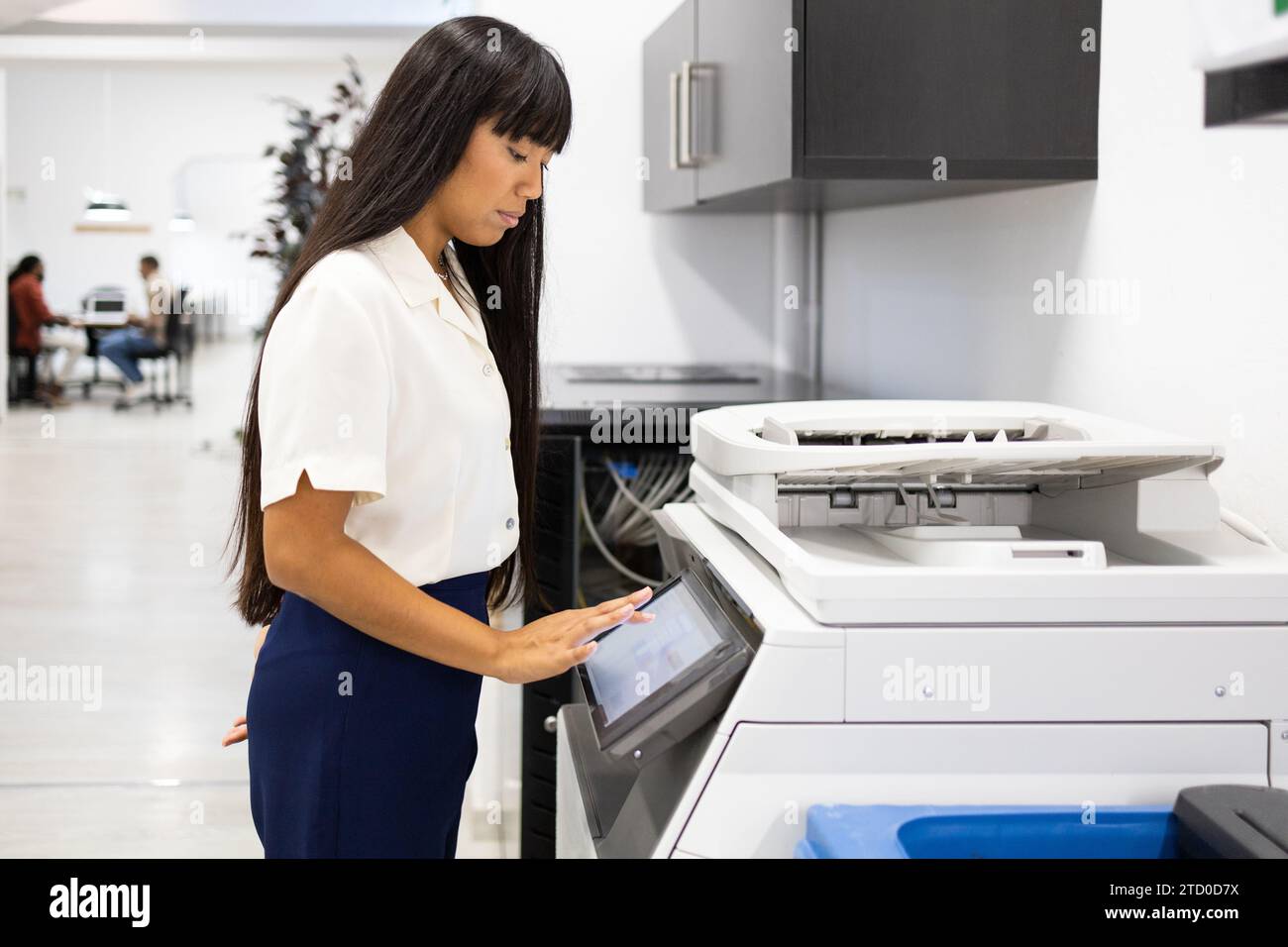 Side view of serious Asian young businesswoman in casuals with long ...