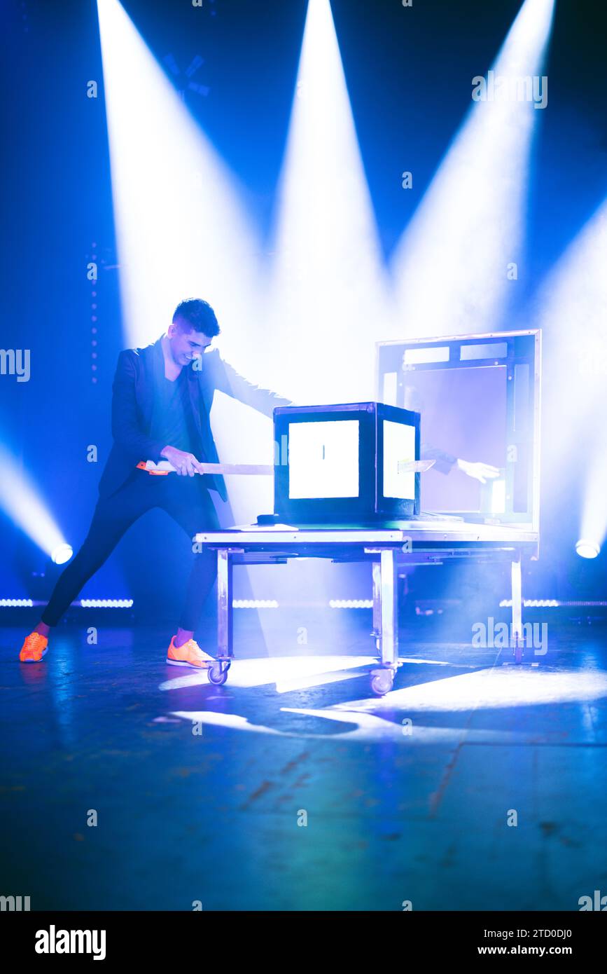 Professional male magician showing magic trick with glass boxes on ...