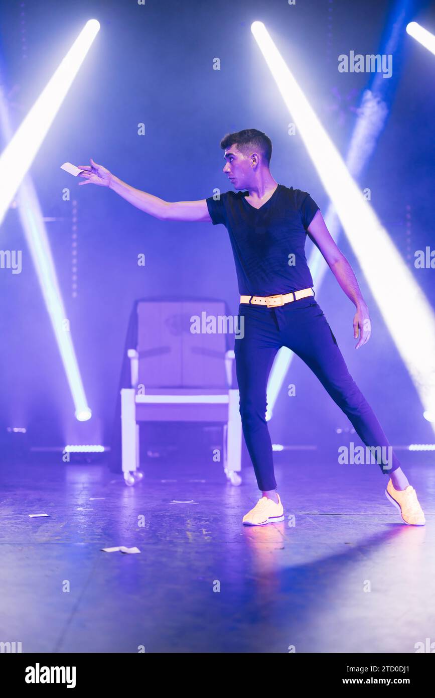 Full body of male illusionist showing magic trick with cards on stage ...
