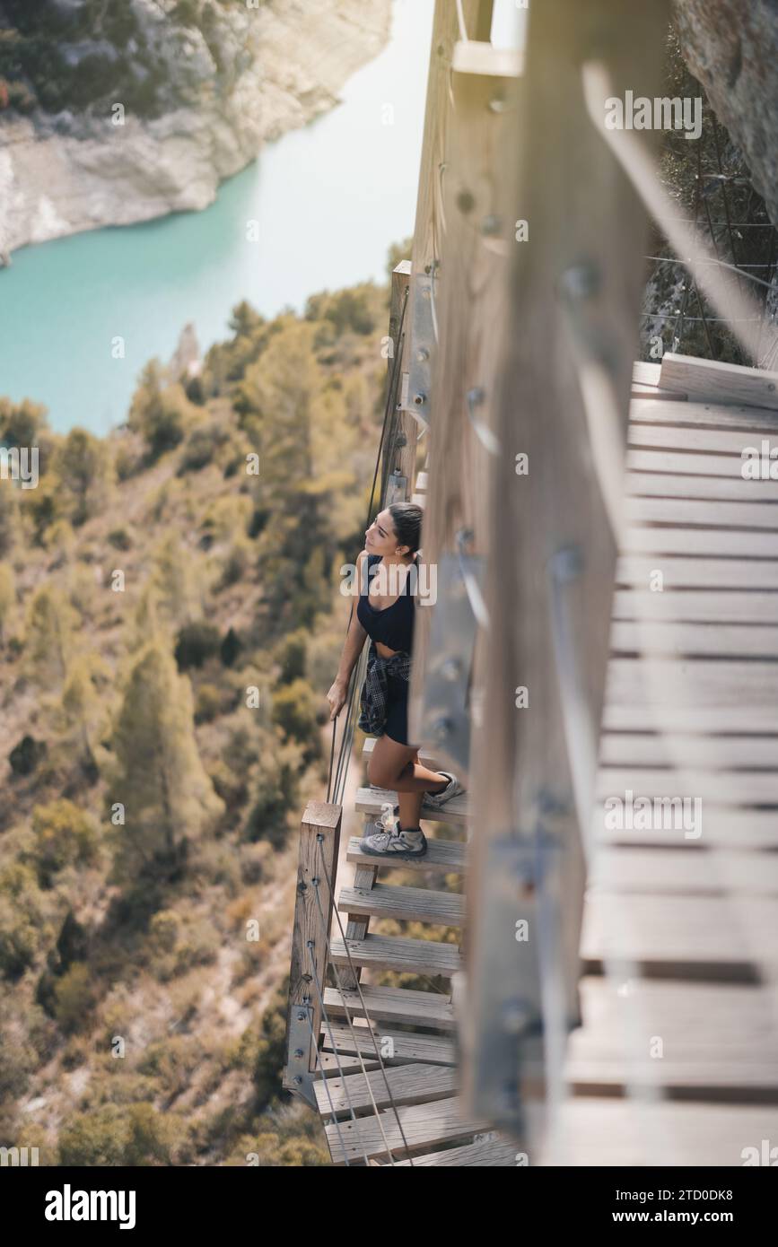High angle full body of young female traveler looking away and admiring ...