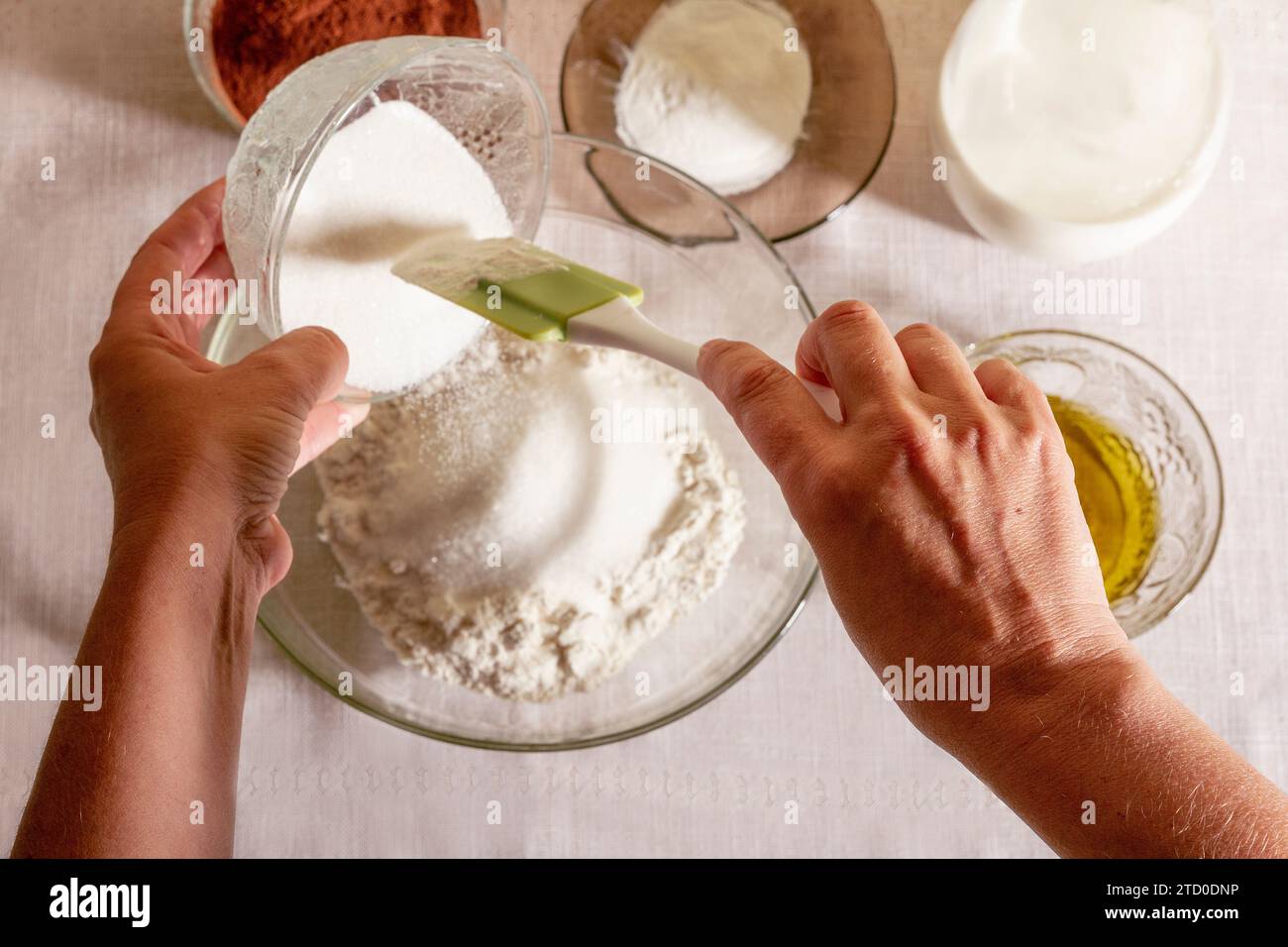 Top view of Hands of crop anonymous person pouring sugar into a glass ...