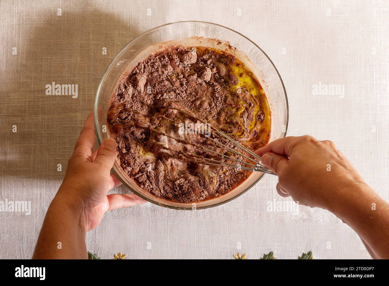 Top view of Hands of anonymous person using a whisk to mix chocolate ...