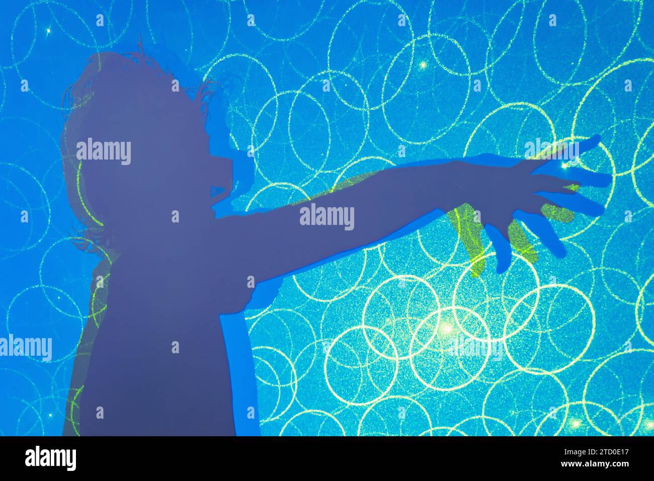 Shadow of anonymous boy in 3D glasses gesturing on wall with ...