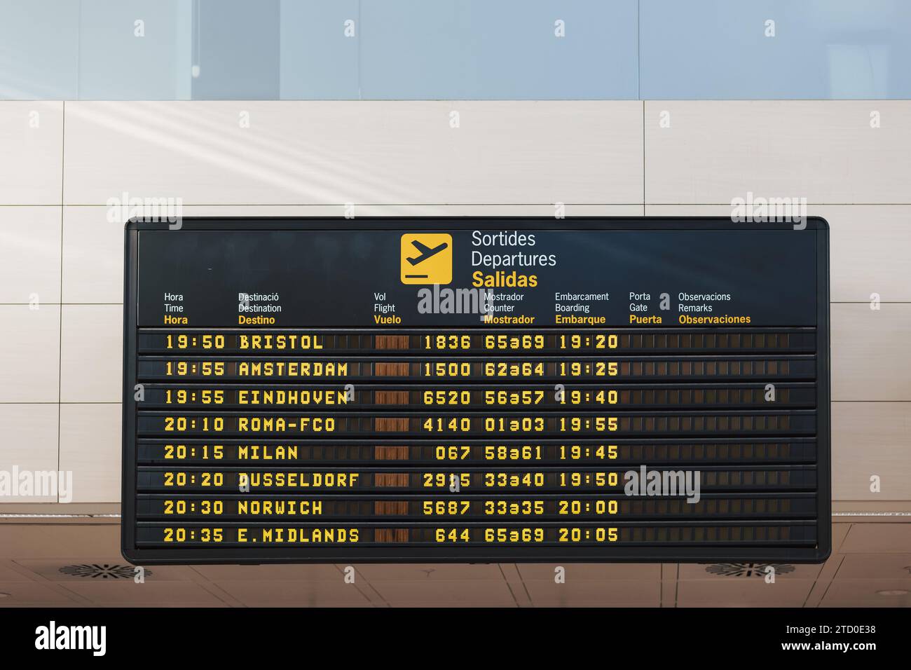 A digital departure board displays flight times and gate information in ...