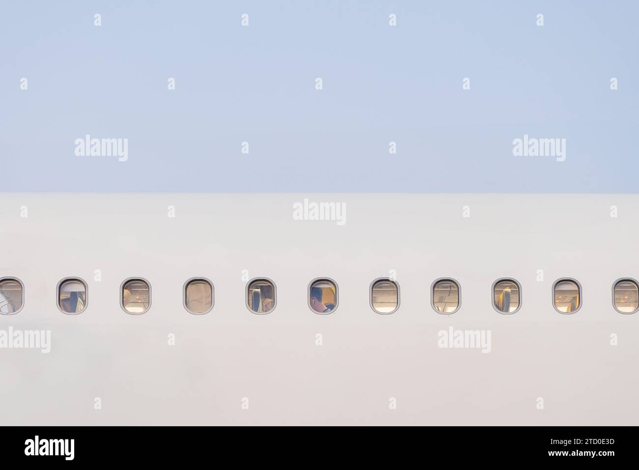 A side view of multiple windows along the fuselage of an airplane ...