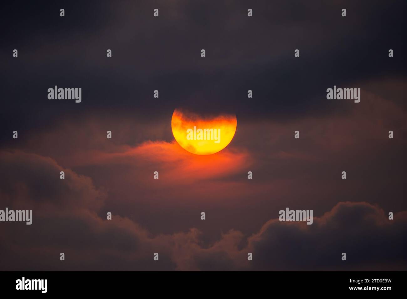 A striking image of a partial solar eclipse captured as the sun peeks ...