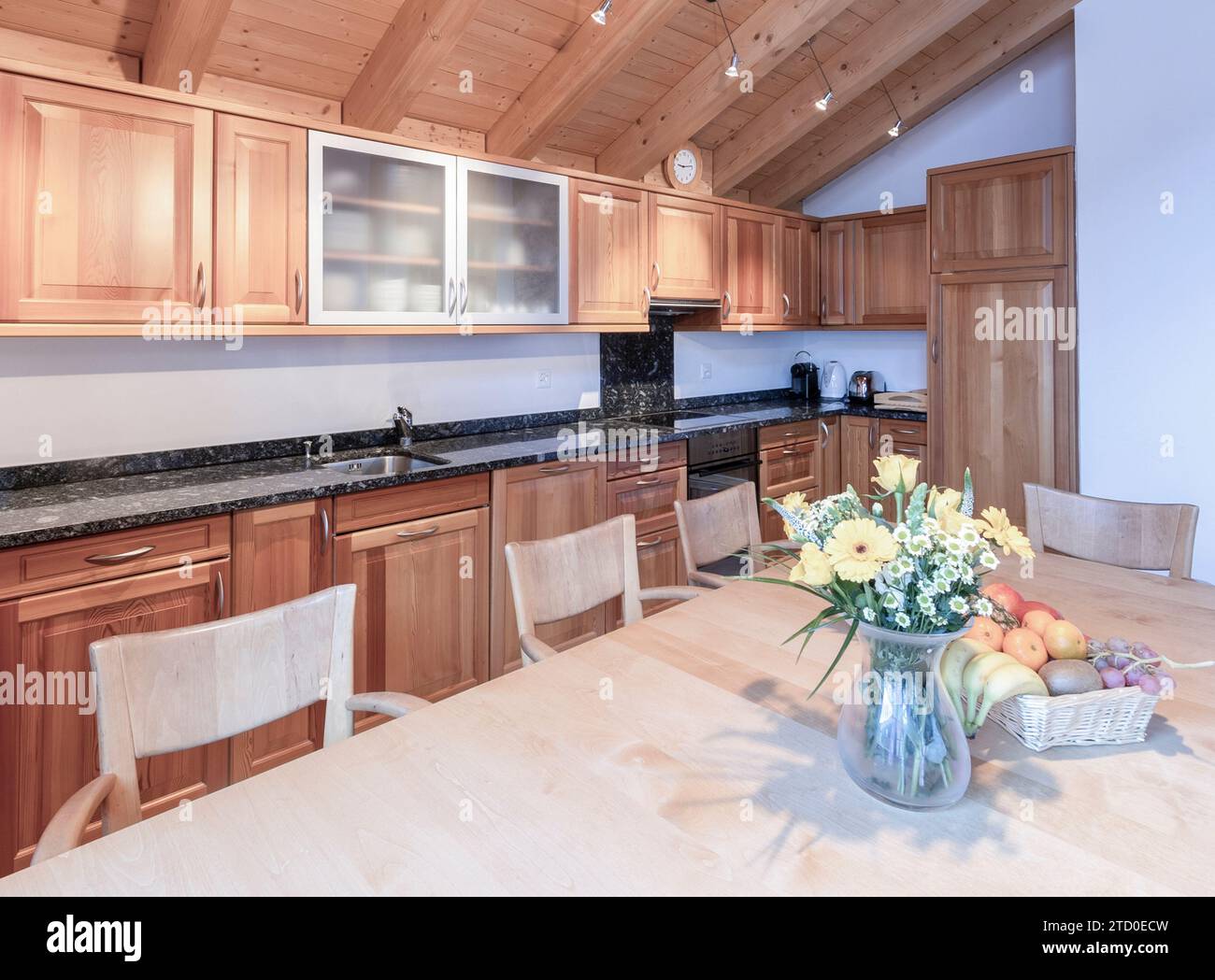 Alpine cabin kitchen featuring wooden cabinets, granite countertops ...