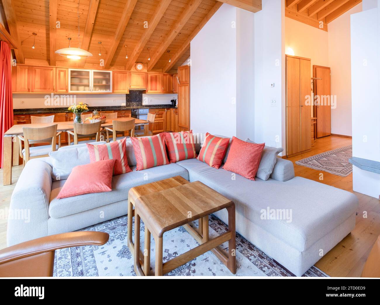 An inviting living room inside a chalet, featuring a plush sofa, wooden ...