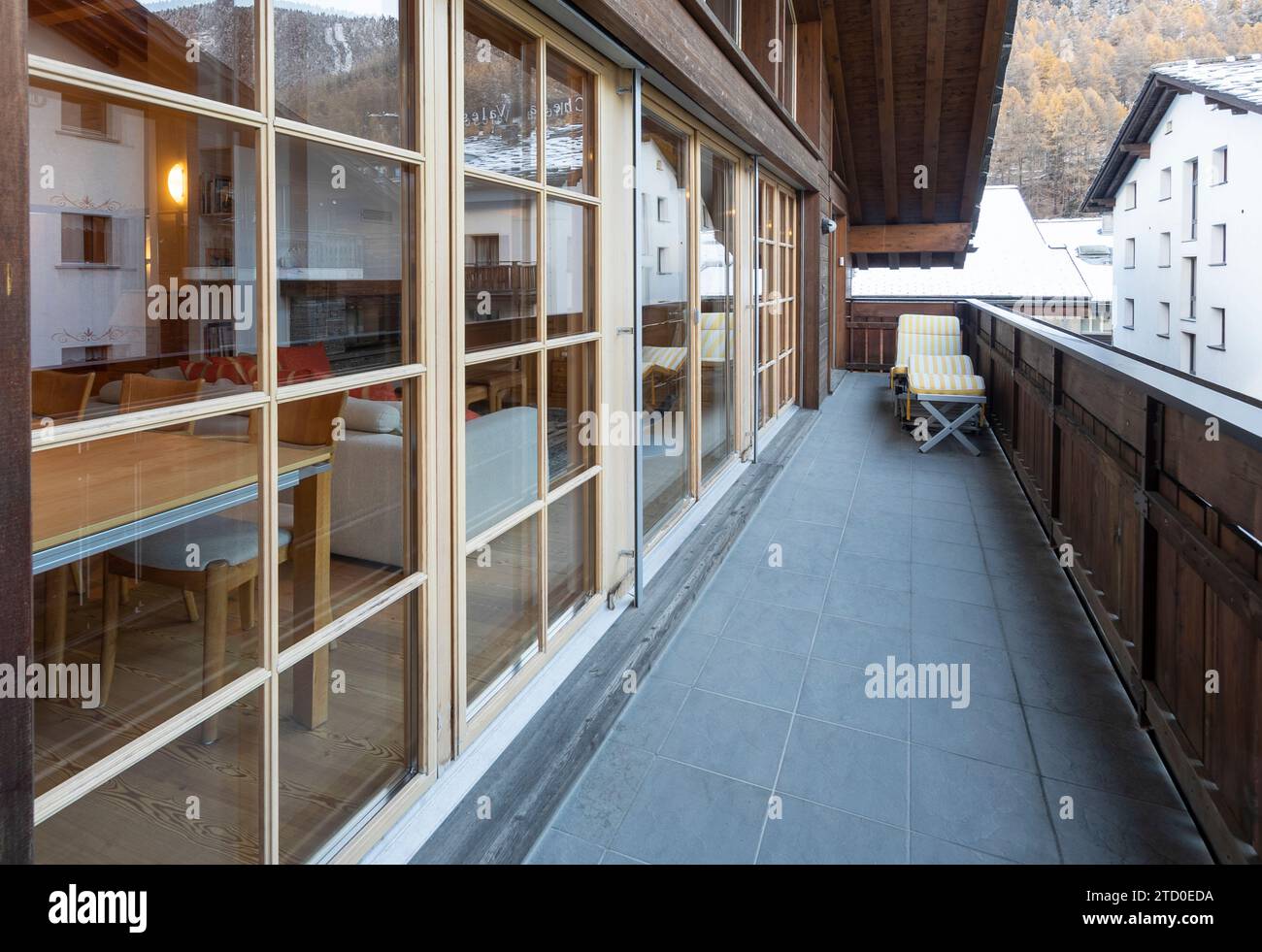 A charming balcony overlooking traditional Swiss architecture with the ...