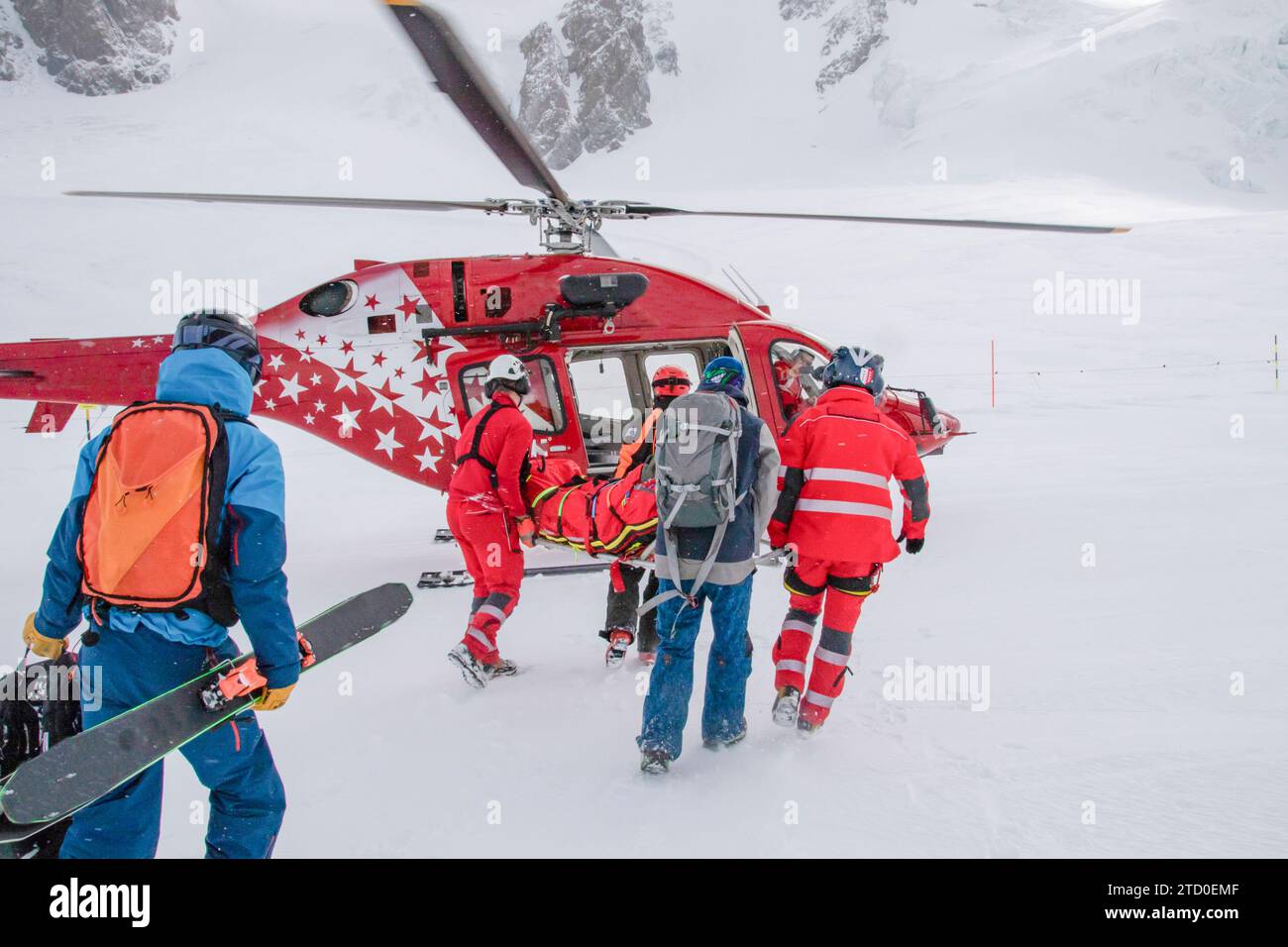 Back view of unrecognizable rescue personnel carrying stretcher with ...