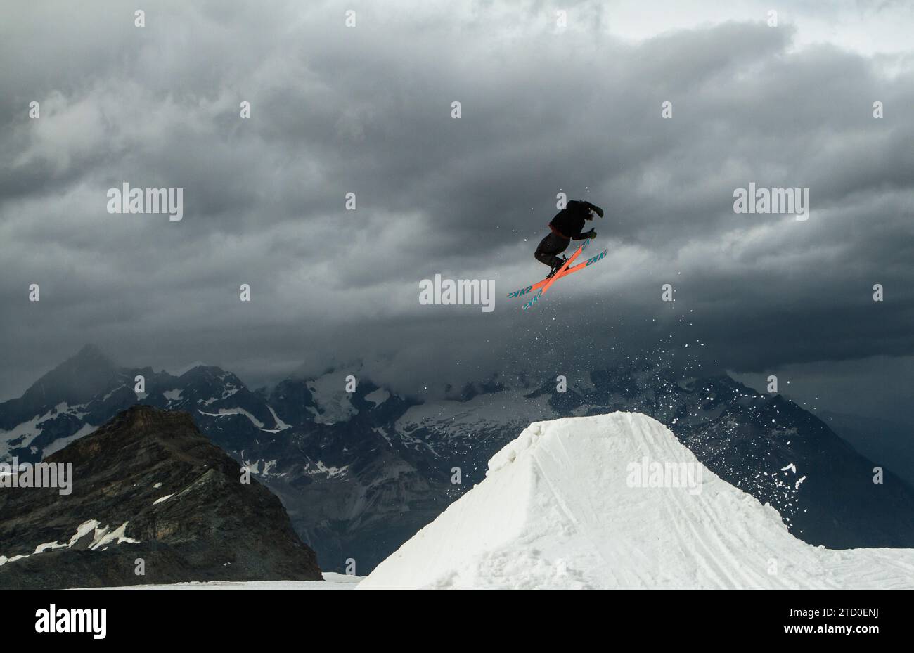 Full body of adventures unrecognizable person with skies jumping in mid ...