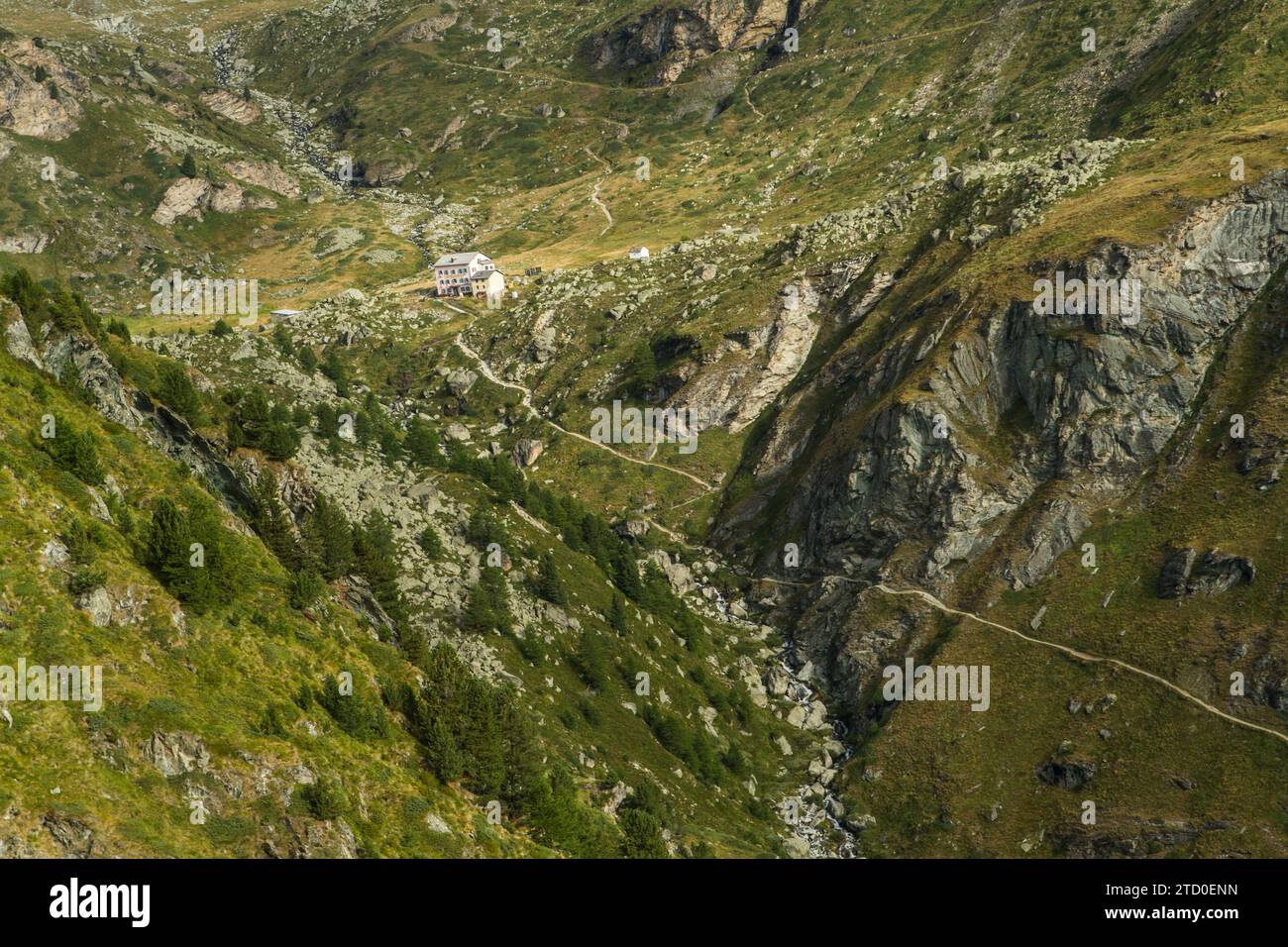 Aerial view of residential building on rocky hillside surrounded with ...