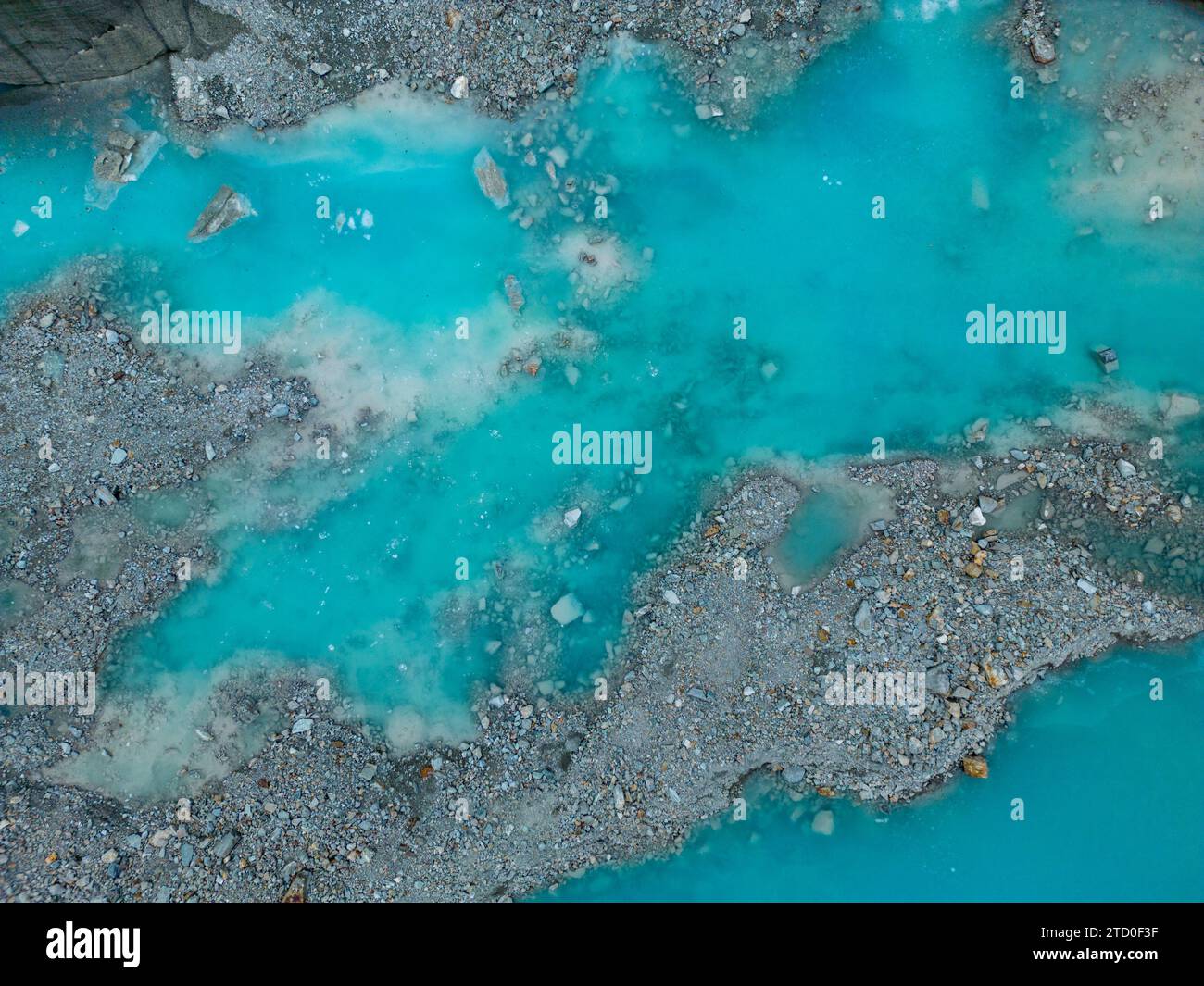 Aerial shot capturing the stunning turquoise hues of a glacier's ...