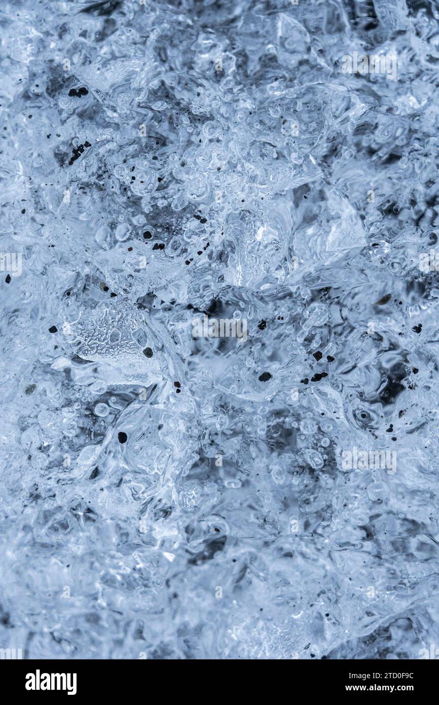 Detailed close-up of glistening ice exhibiting the melting process with ...