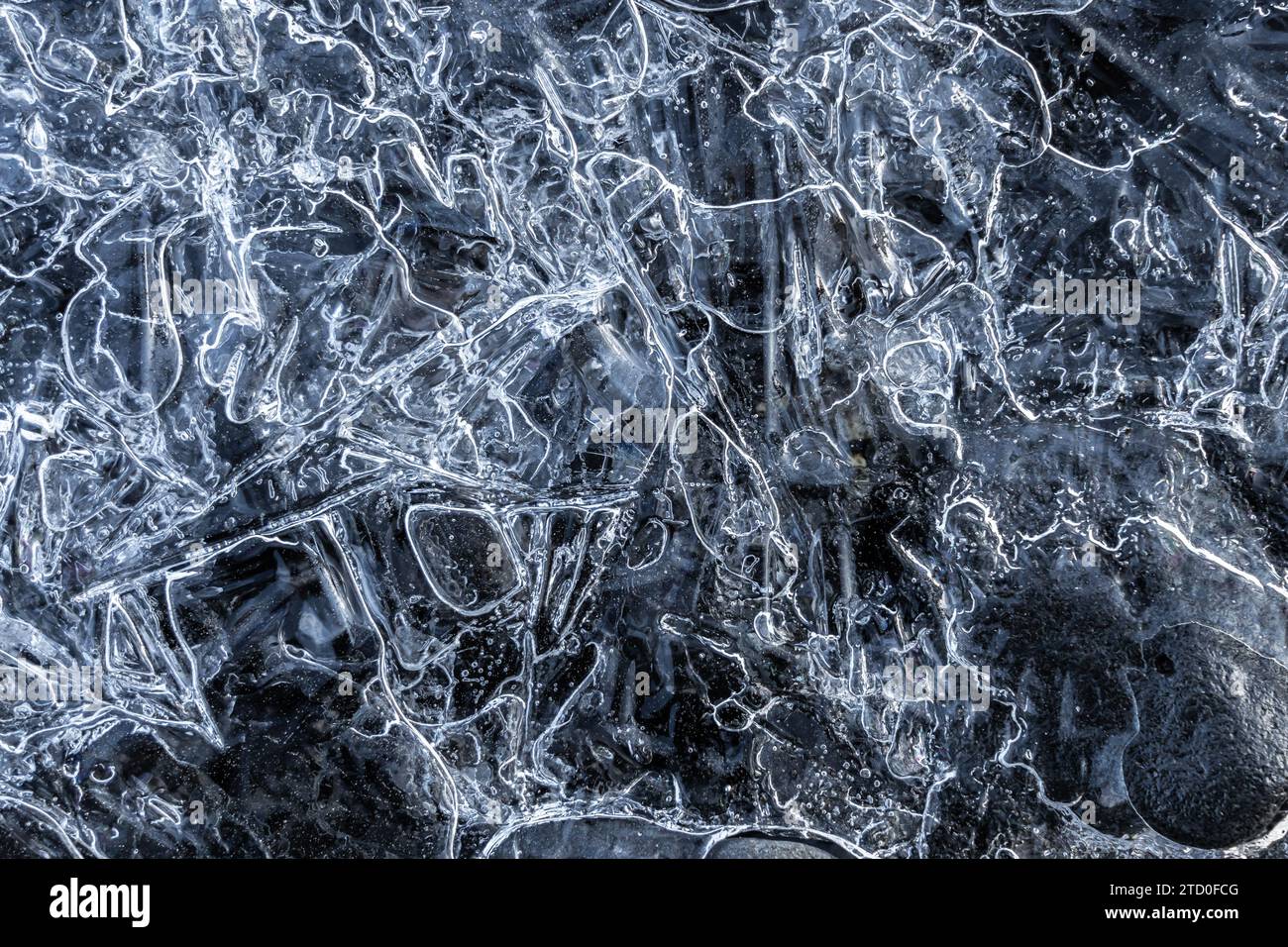 A close-up of a frozen surface showcases intricate ice patterns with ...