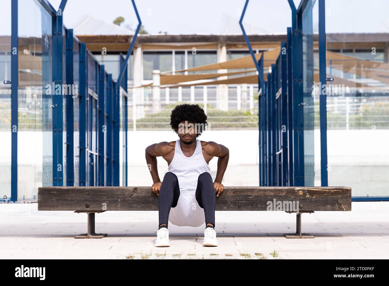 Full body of confident serious African American male athlete balancing ...