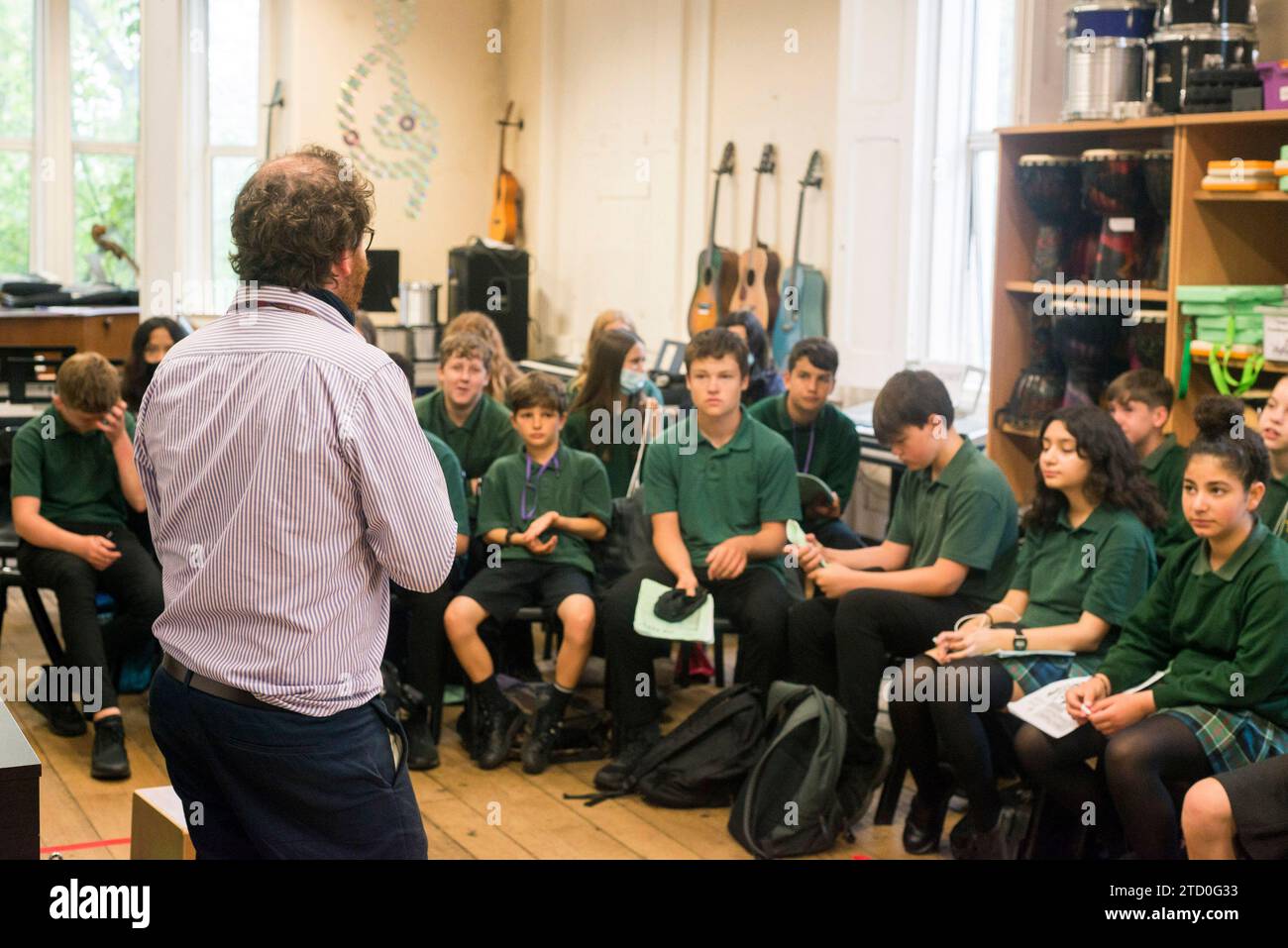 Students in a classroom learning how to play musical instruments Stock ...