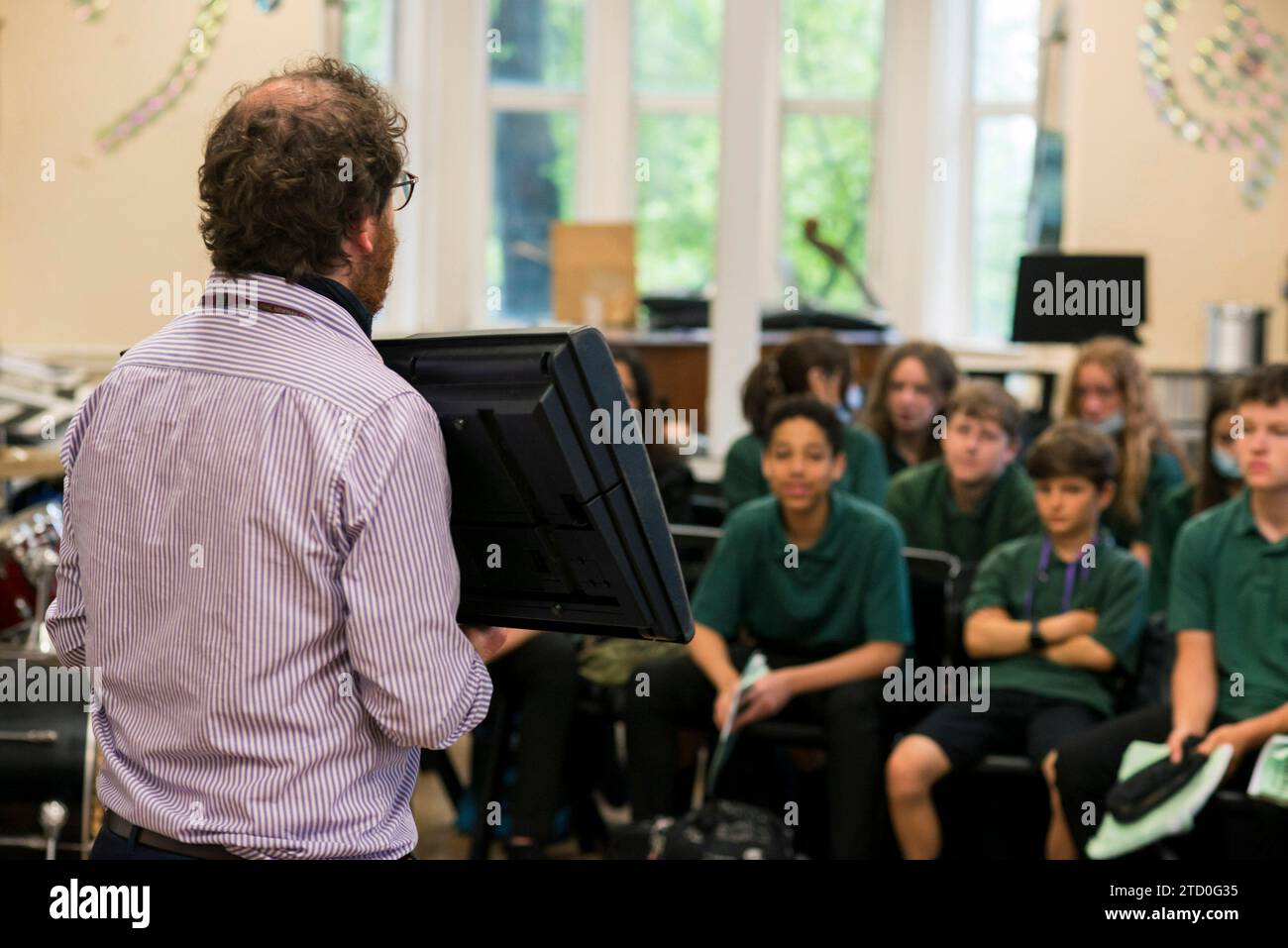 Students in a classroom learning how to play musical instruments Stock ...
