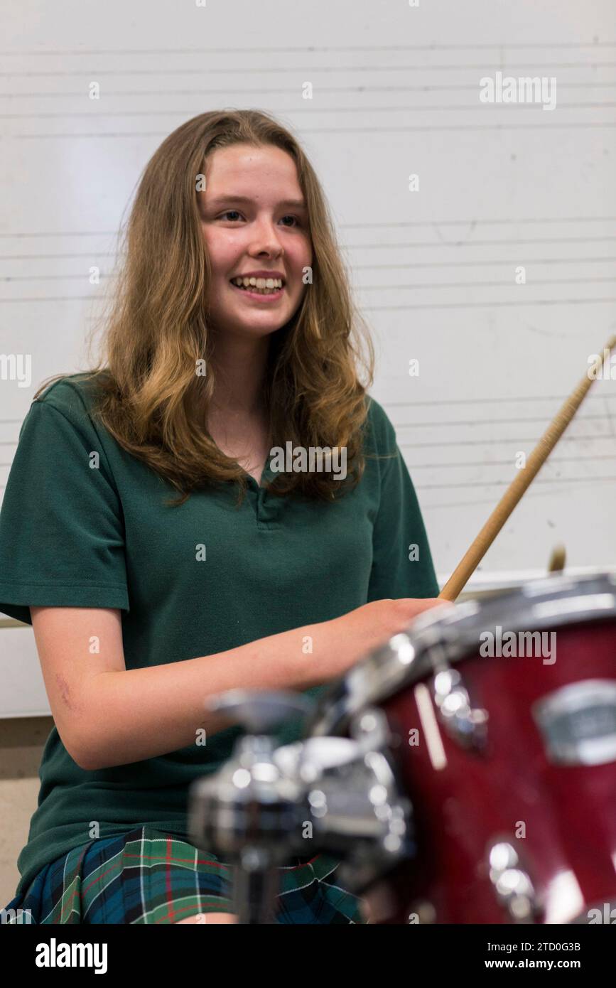 Students in a classroom learning how to play musical instruments Stock ...