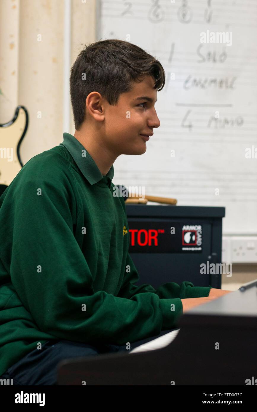 Students in a classroom learning how to play musical instruments Stock ...