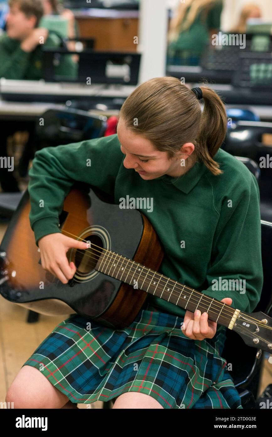 Students in a classroom learning how to play musical instruments Stock ...