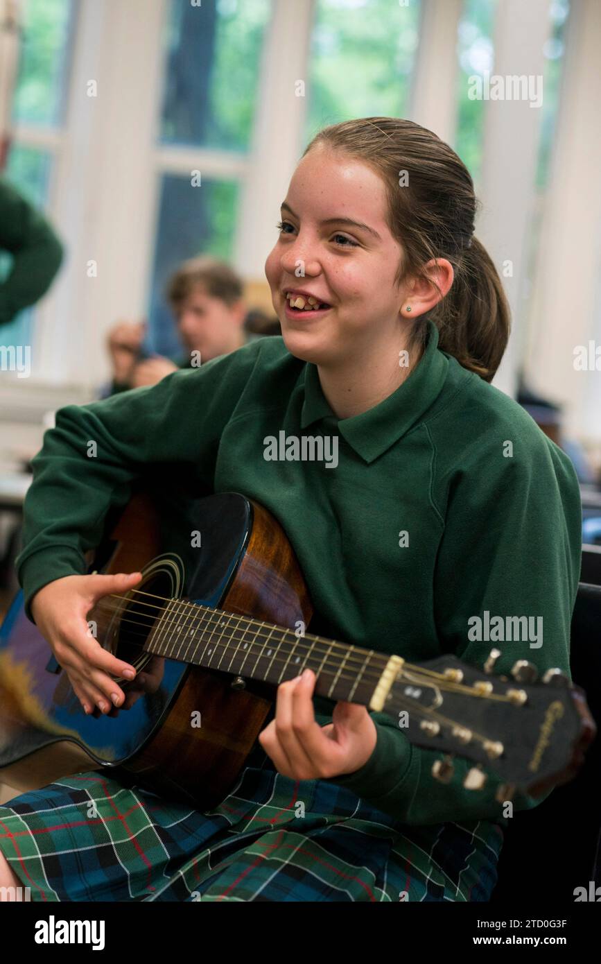 Students in a classroom learning how to play musical instruments Stock ...
