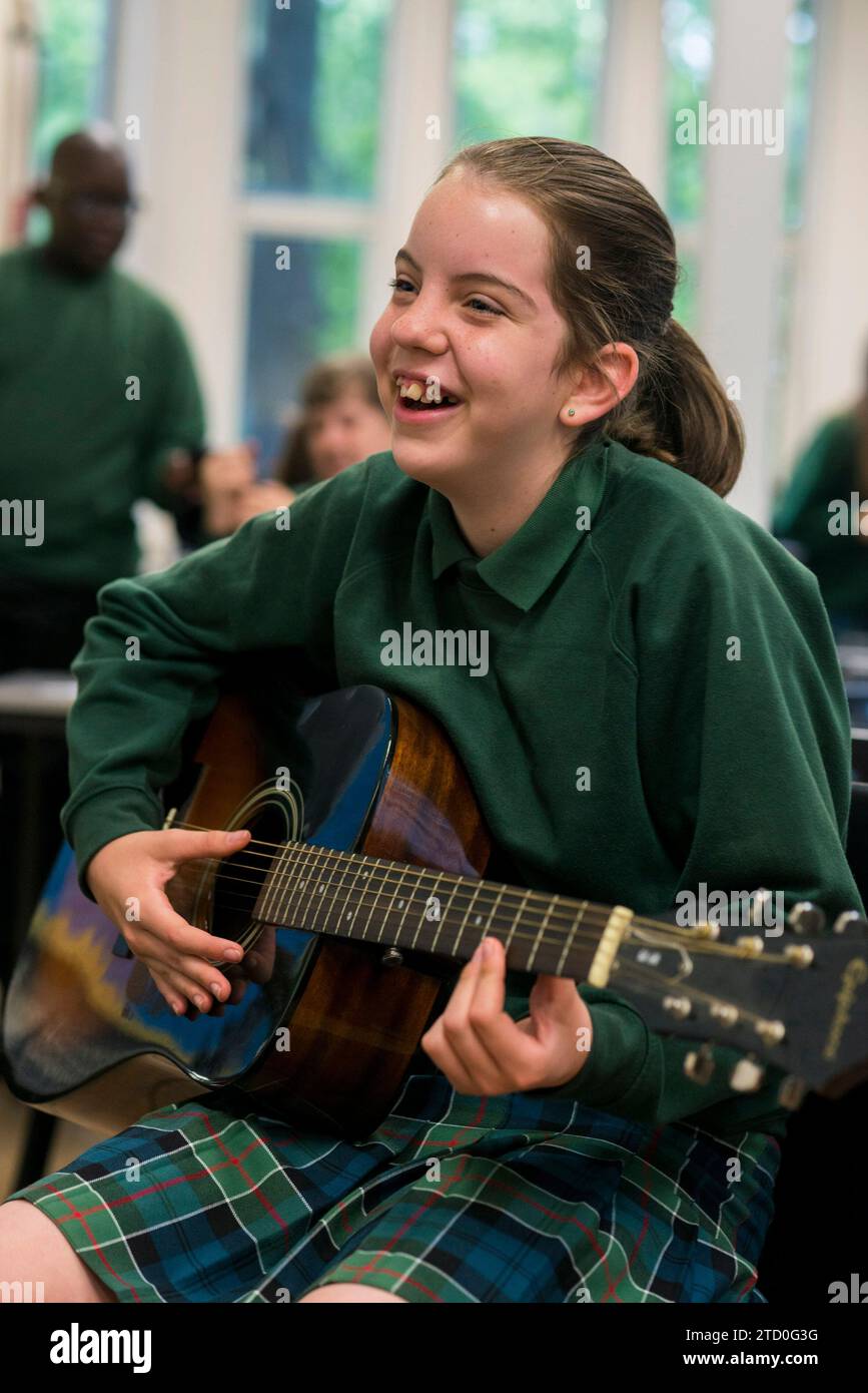 Students in a classroom learning how to play musical instruments Stock ...