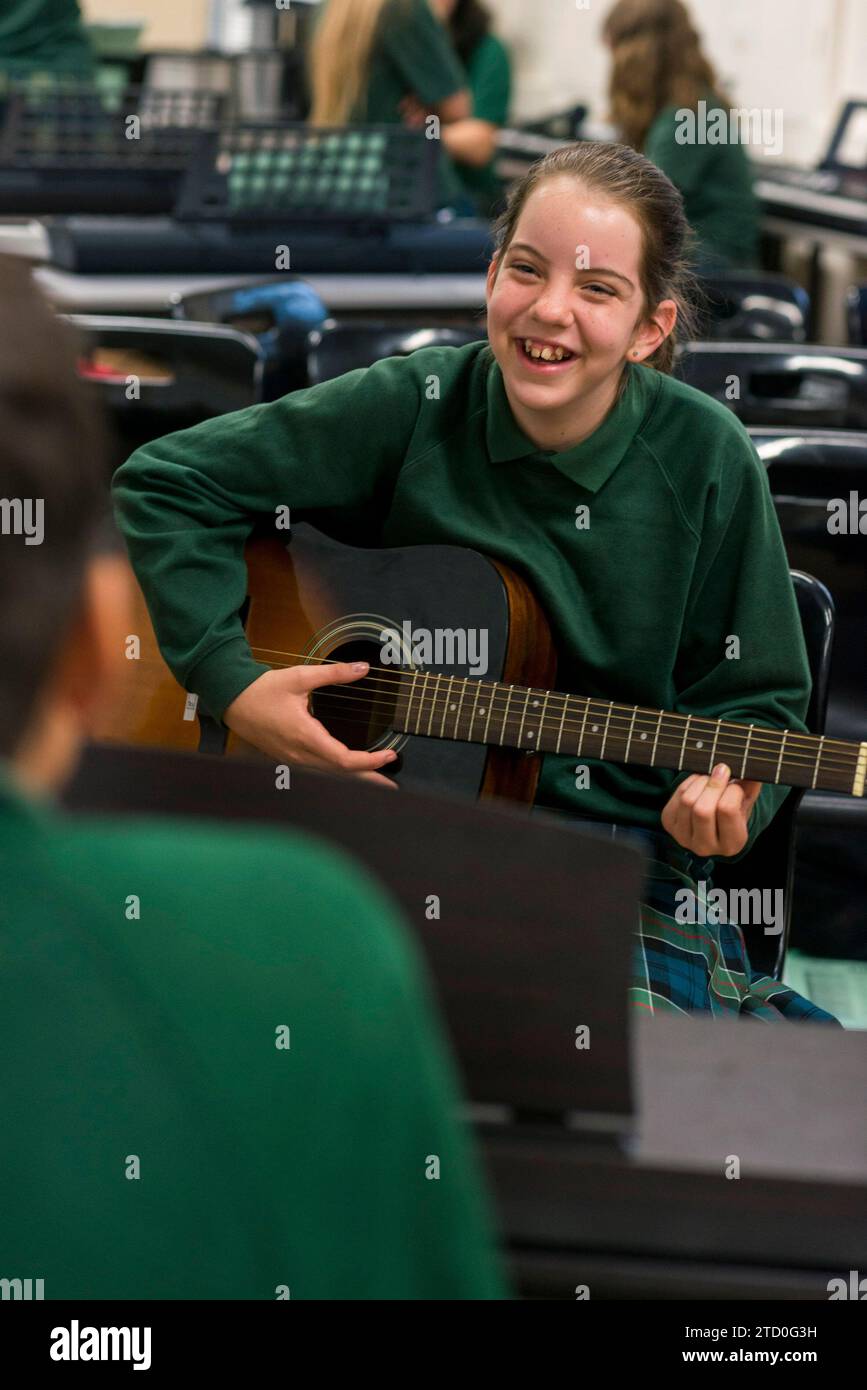 Students in a classroom learning how to play musical instruments Stock ...