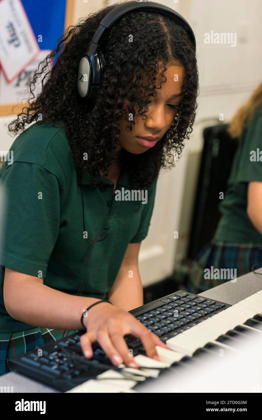 Students in a classroom learning how to play musical instruments Stock ...