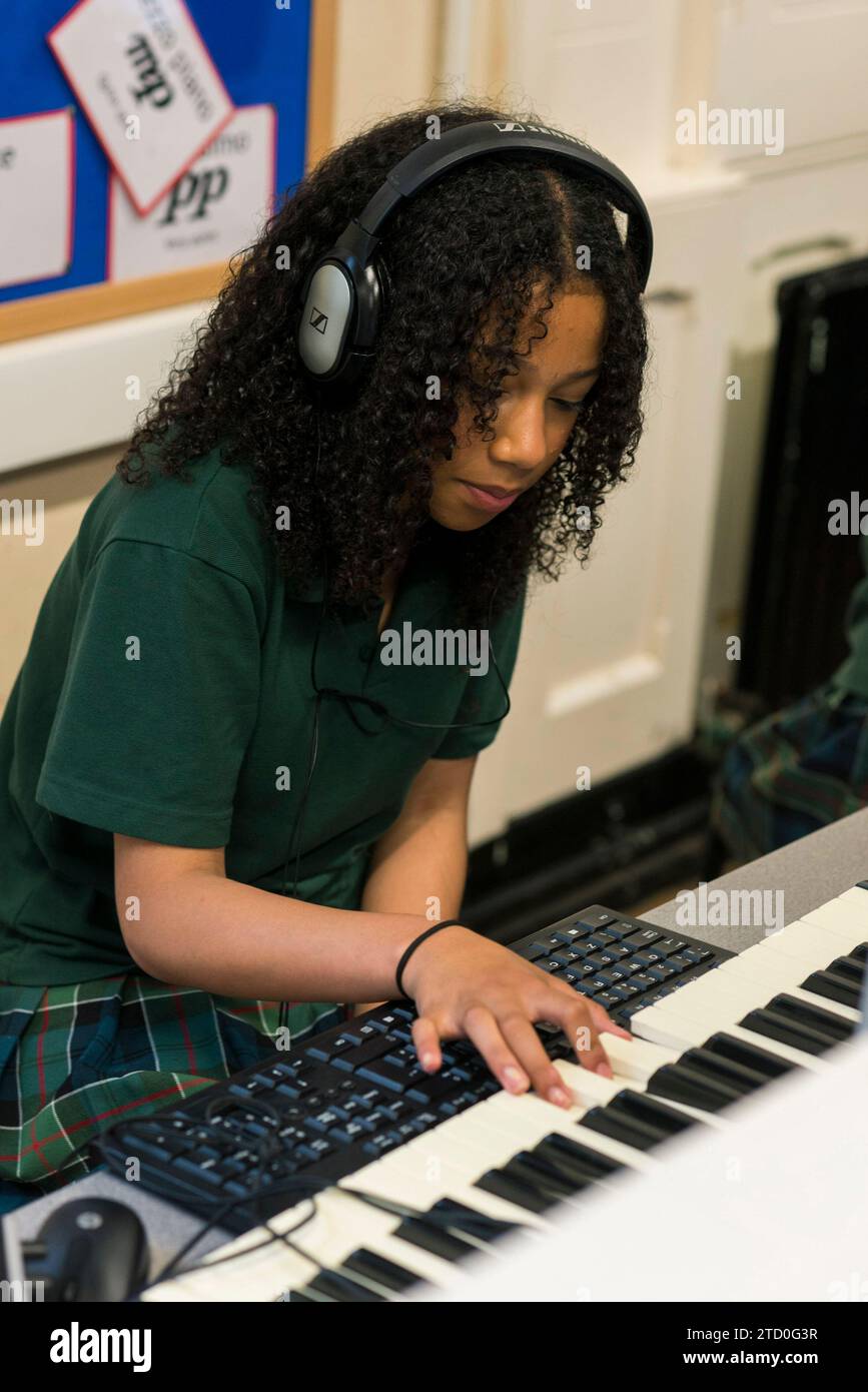 Students in a classroom learning how to play musical instruments Stock ...