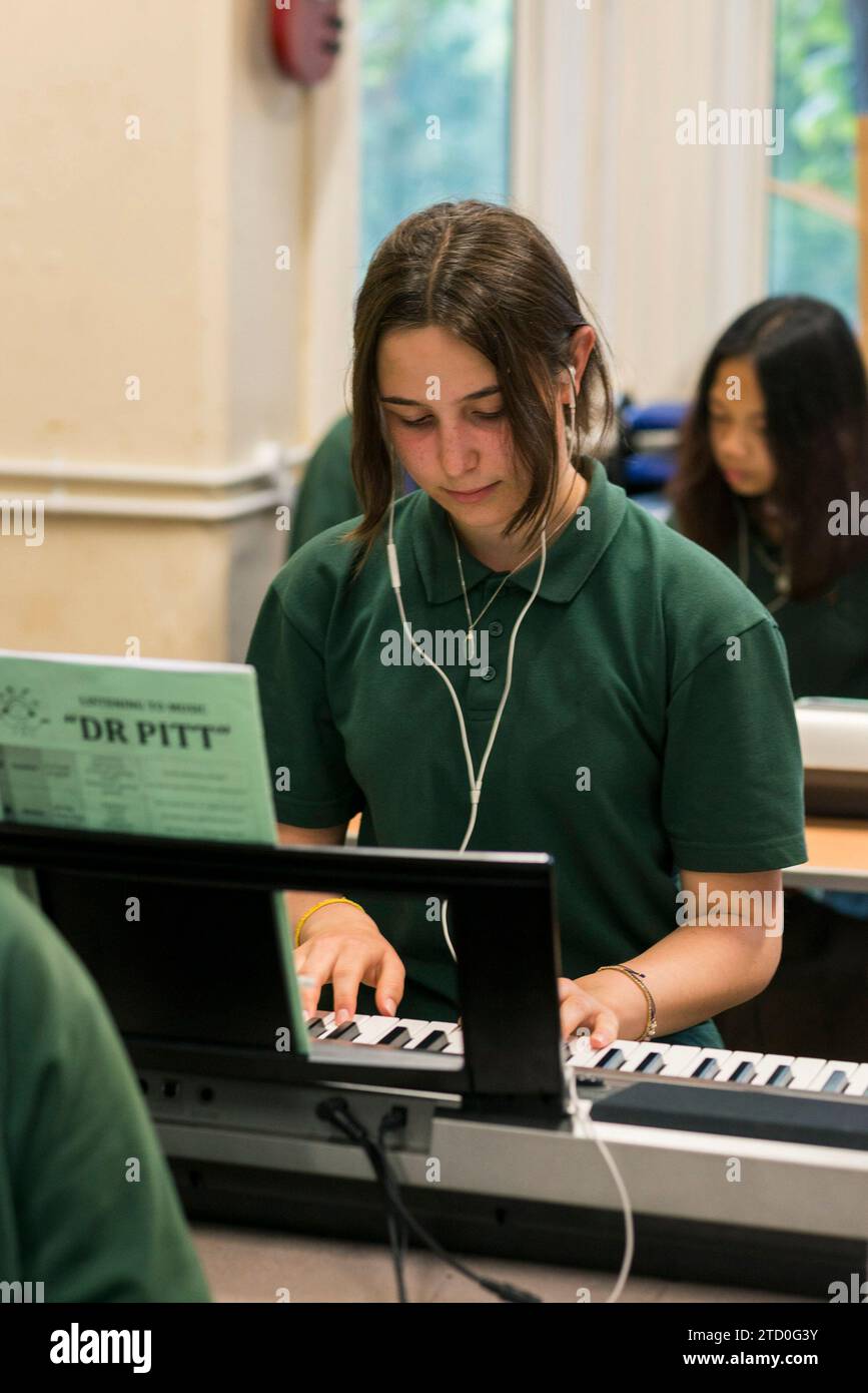 Students in a classroom learning how to play musical instruments Stock ...