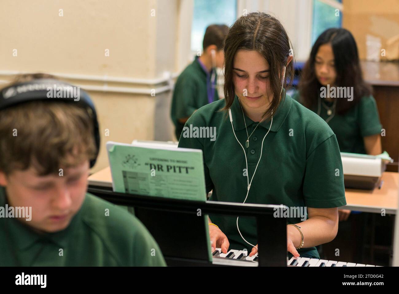 Students in a classroom learning how to play musical instruments Stock ...