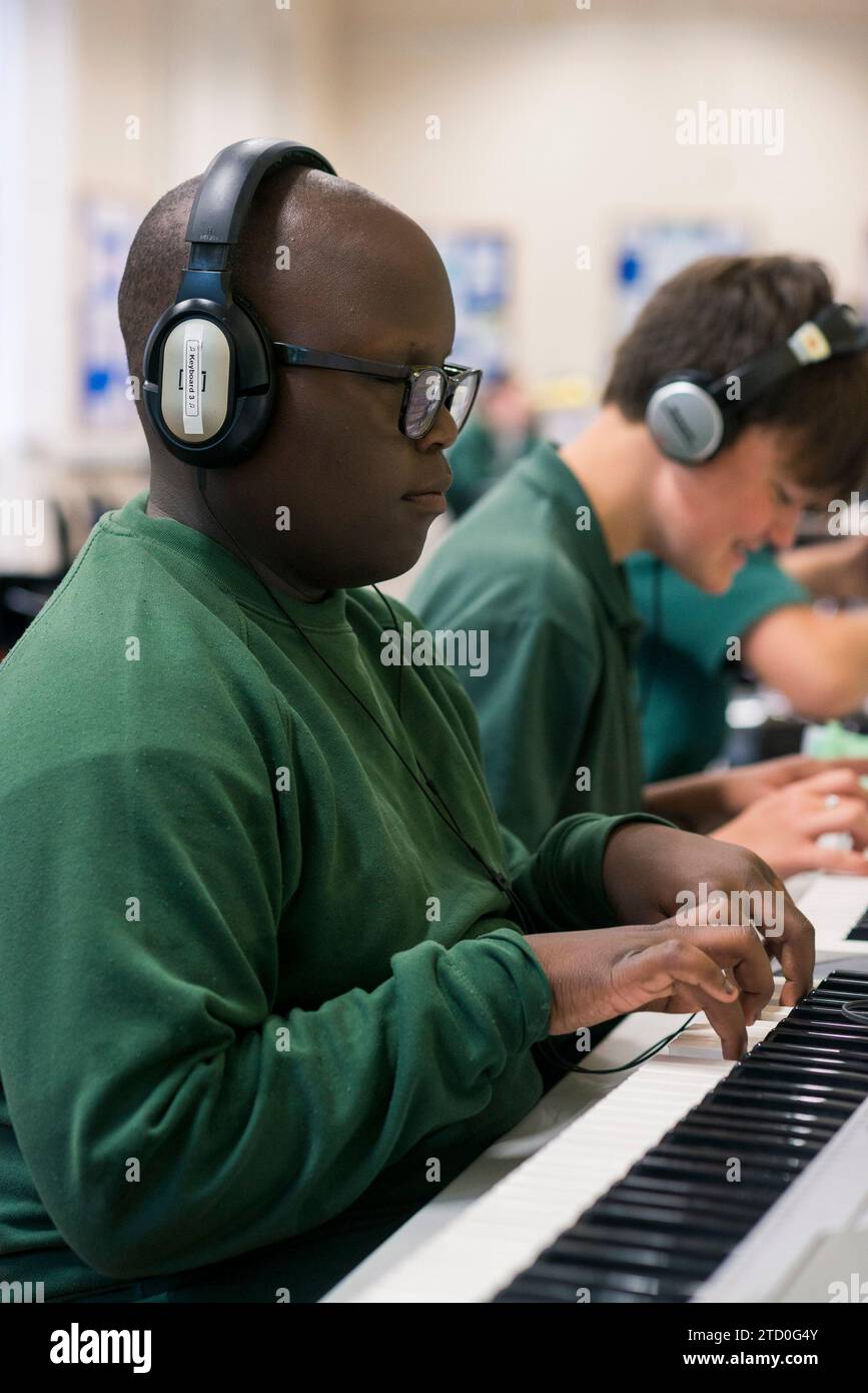 Students in a classroom learning how to play musical instruments Stock ...