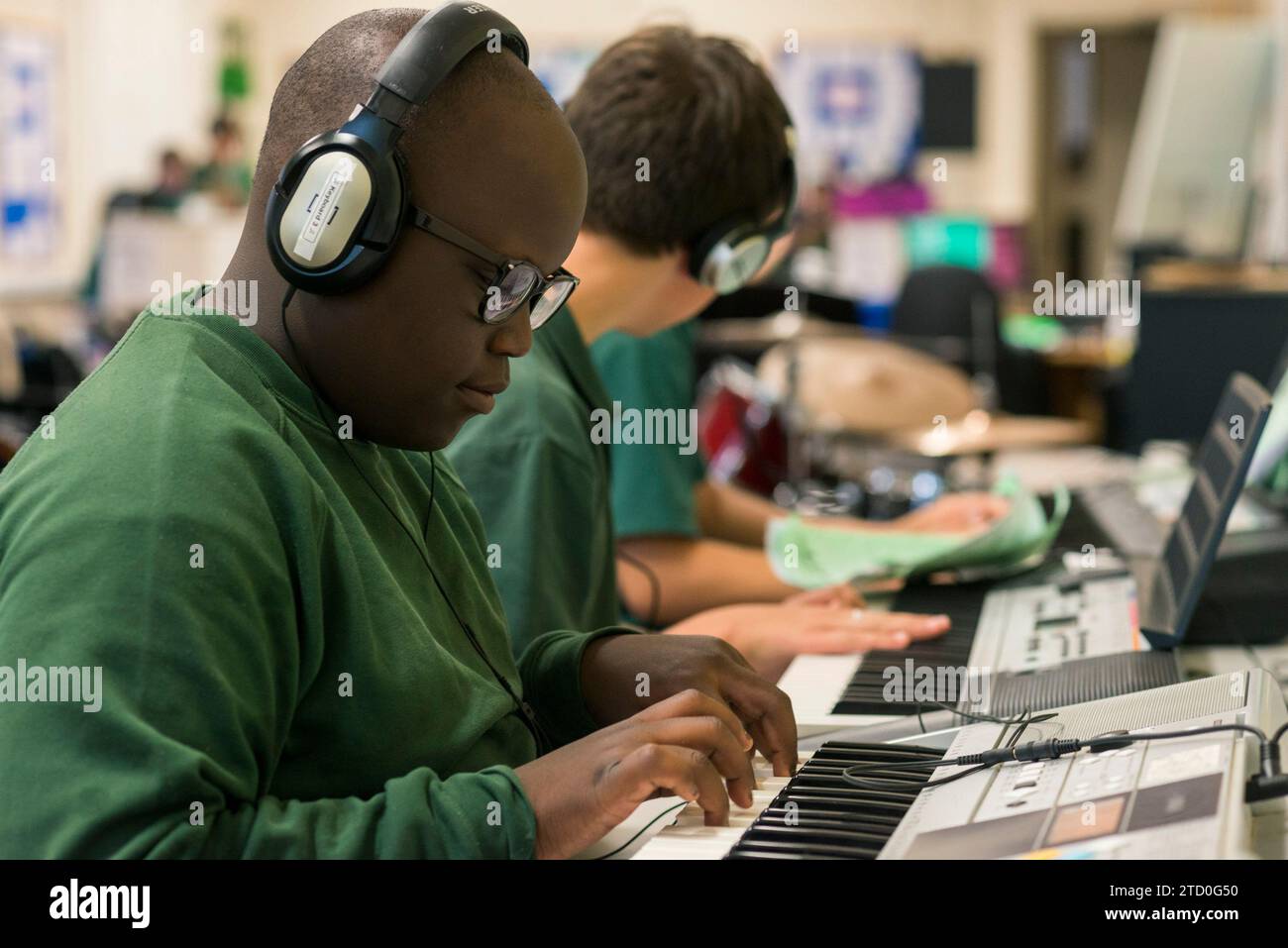 Students in a classroom learning how to play musical instruments Stock ...