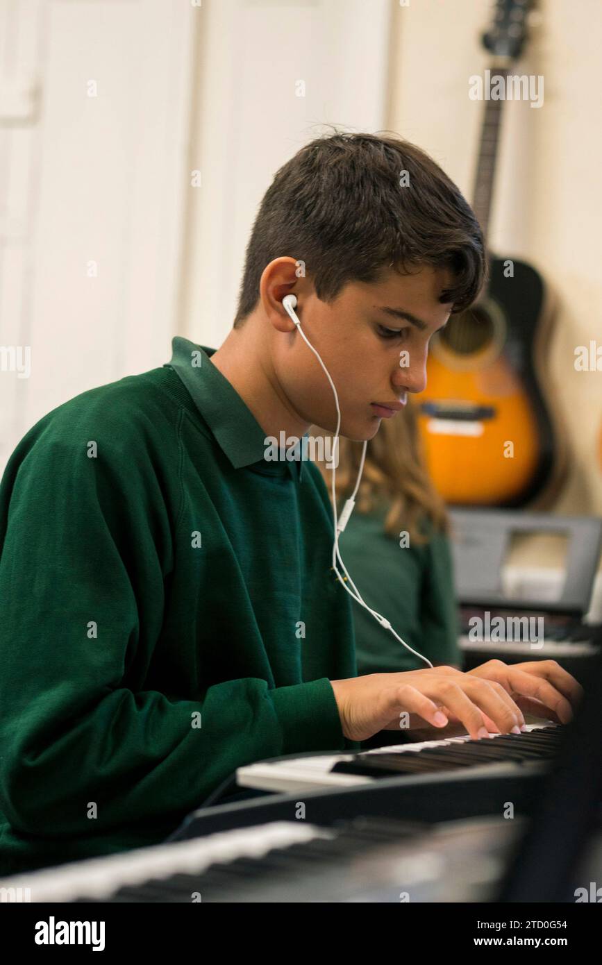 Students in a classroom learning how to play musical instruments Stock ...