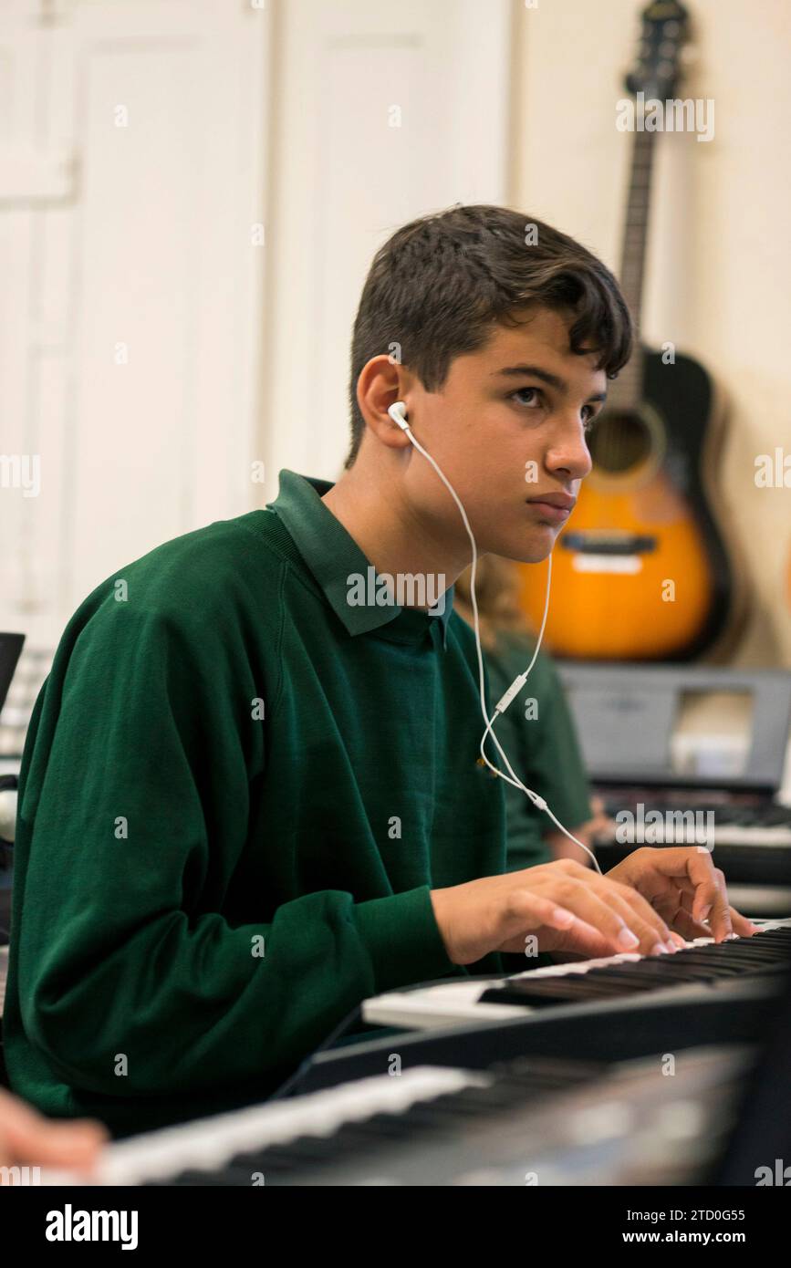 Students in a classroom learning how to play musical instruments Stock ...