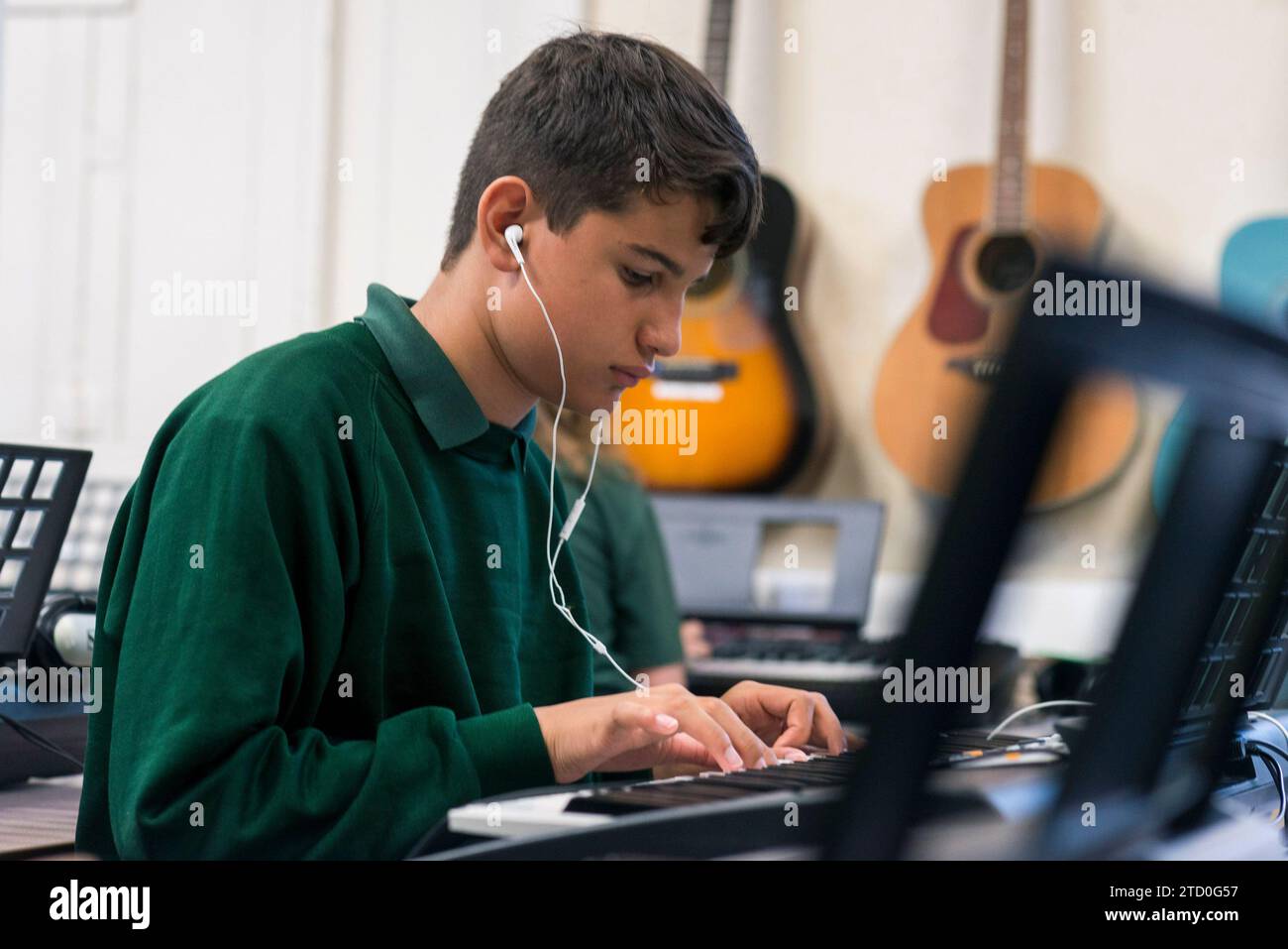 Students in a classroom learning how to play musical instruments Stock ...