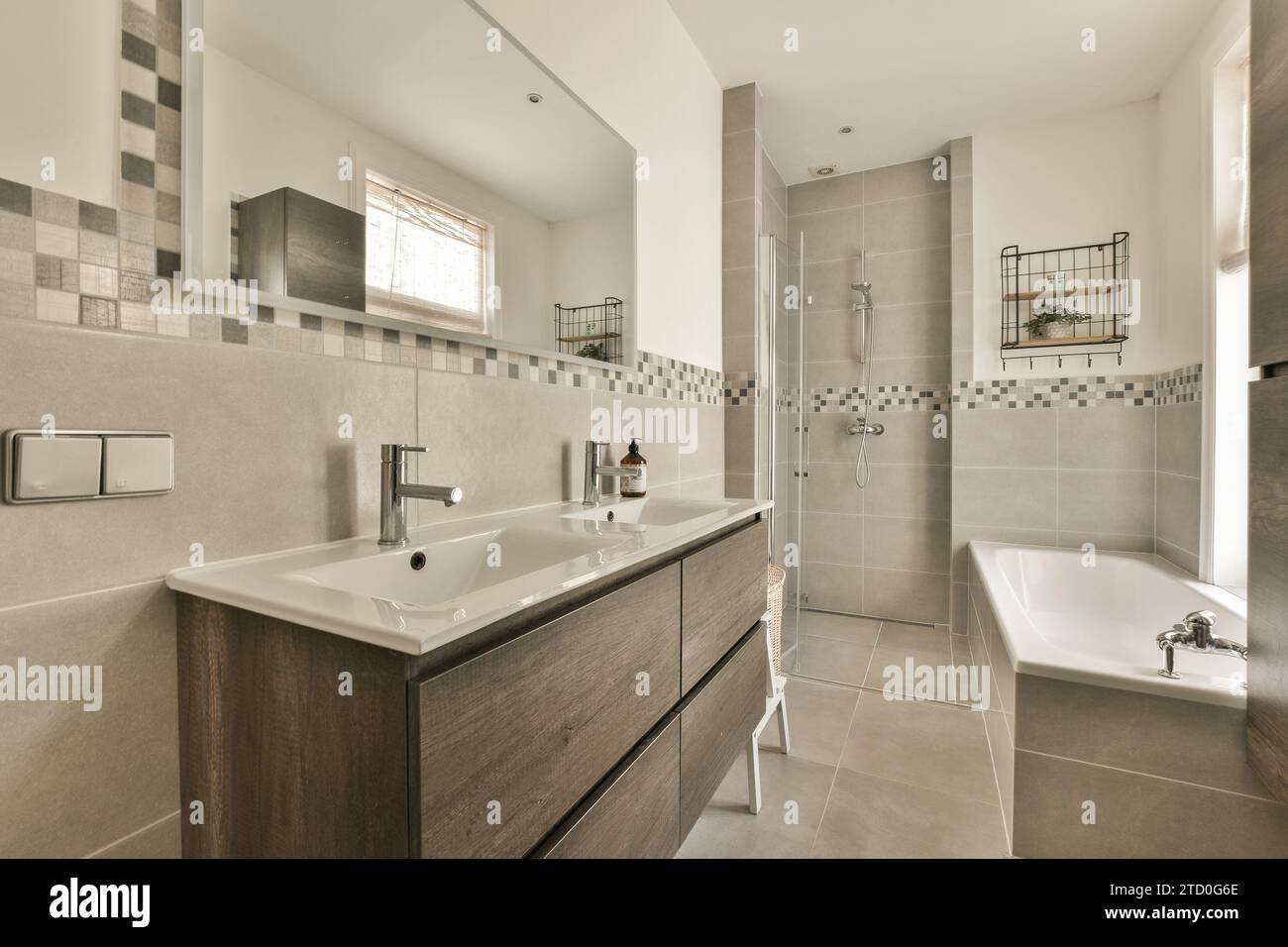 Mirror with reflection over sink by bathtub and shower booth in ...