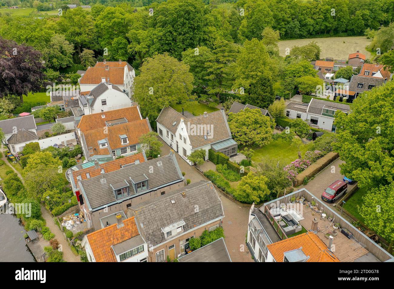 Aerial view of residential buildings with roof tiles and beautiful lush ...