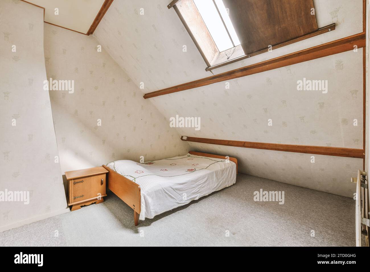 Cozy small bed on carpeted floor of loft room of modern home with ...