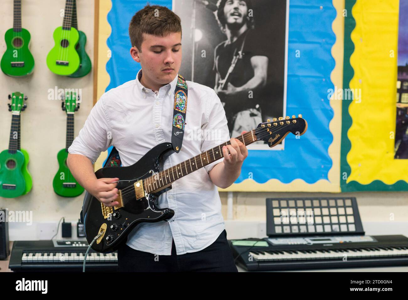 Students in a classroom learning how to play musical instruments Stock ...