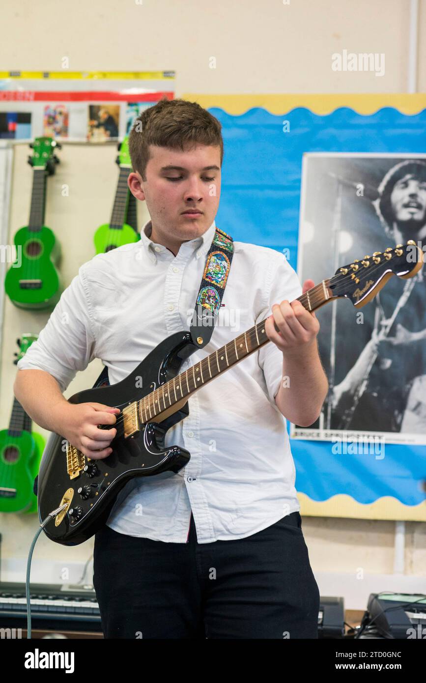 Students in a classroom learning how to play musical instruments Stock ...