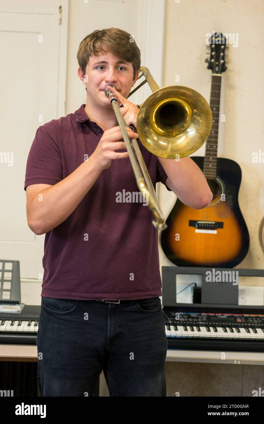Students in a classroom learning how to play musical instruments Stock ...