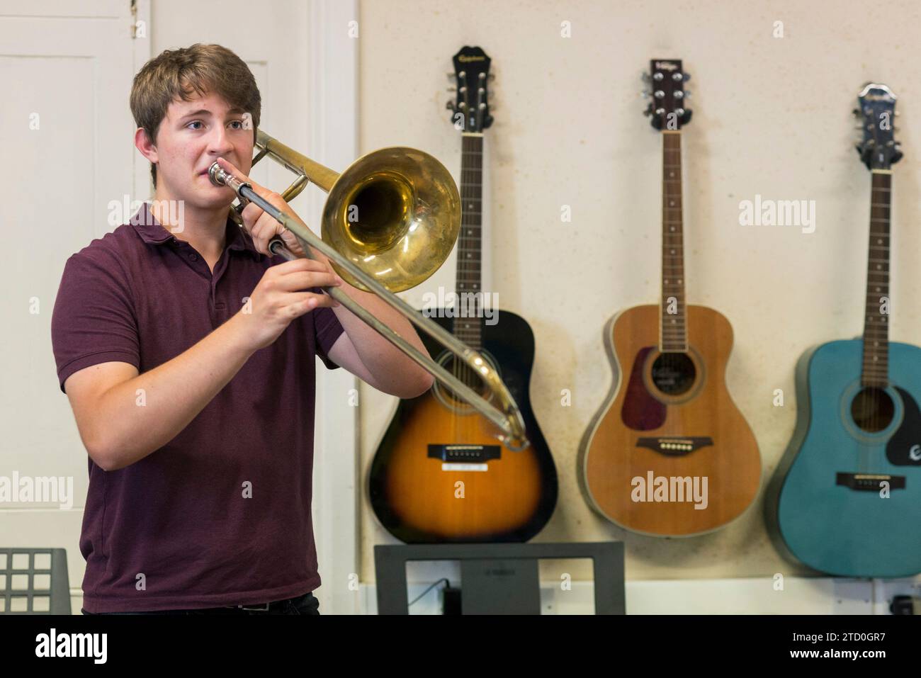 Students in a classroom learning how to play musical instruments Stock ...
