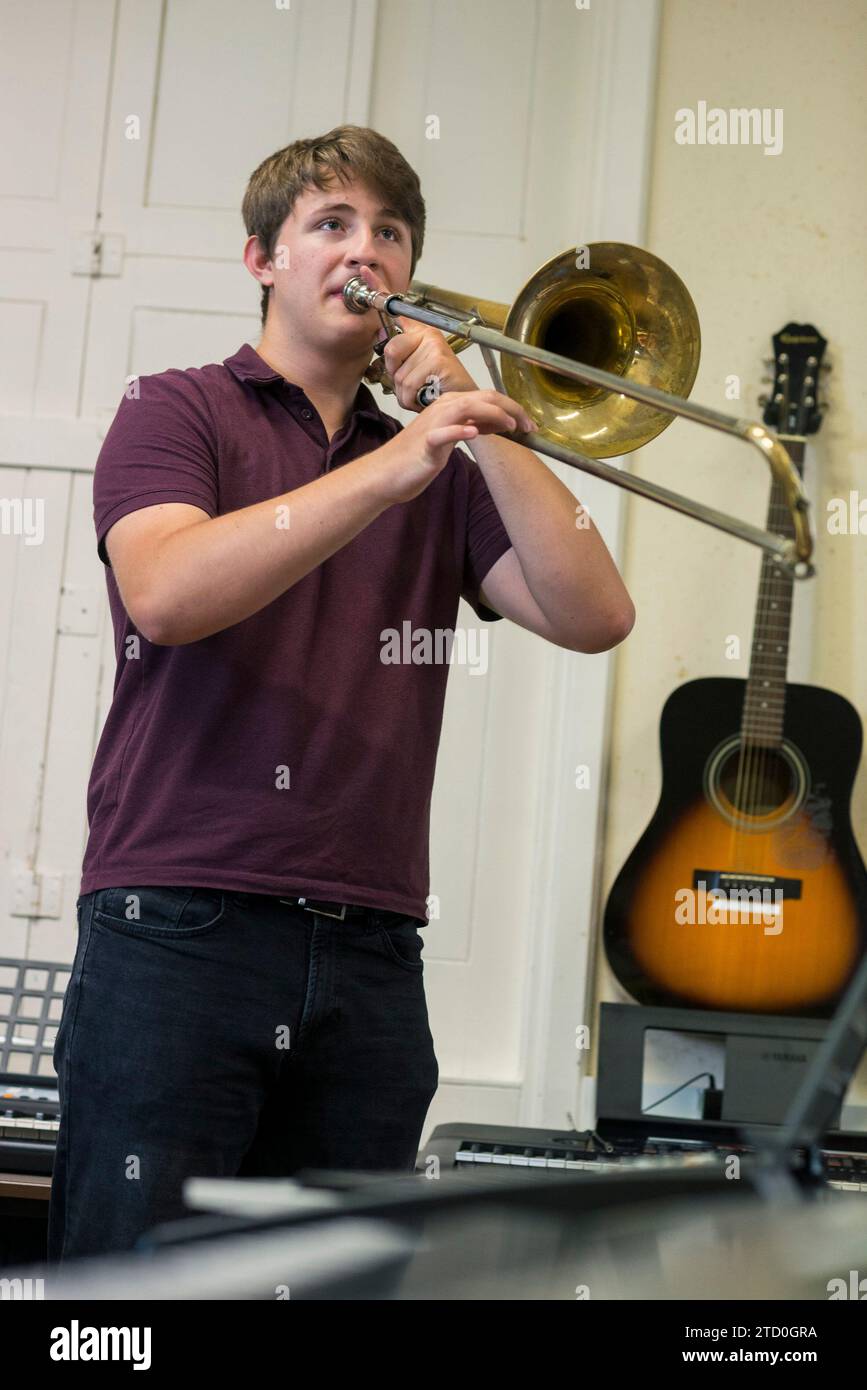 Students in a classroom learning how to play musical instruments Stock ...