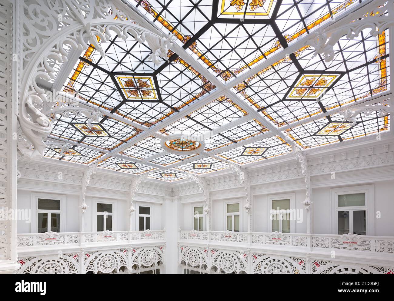 Low angle of skylight with stained glass design and carvings inside of ...