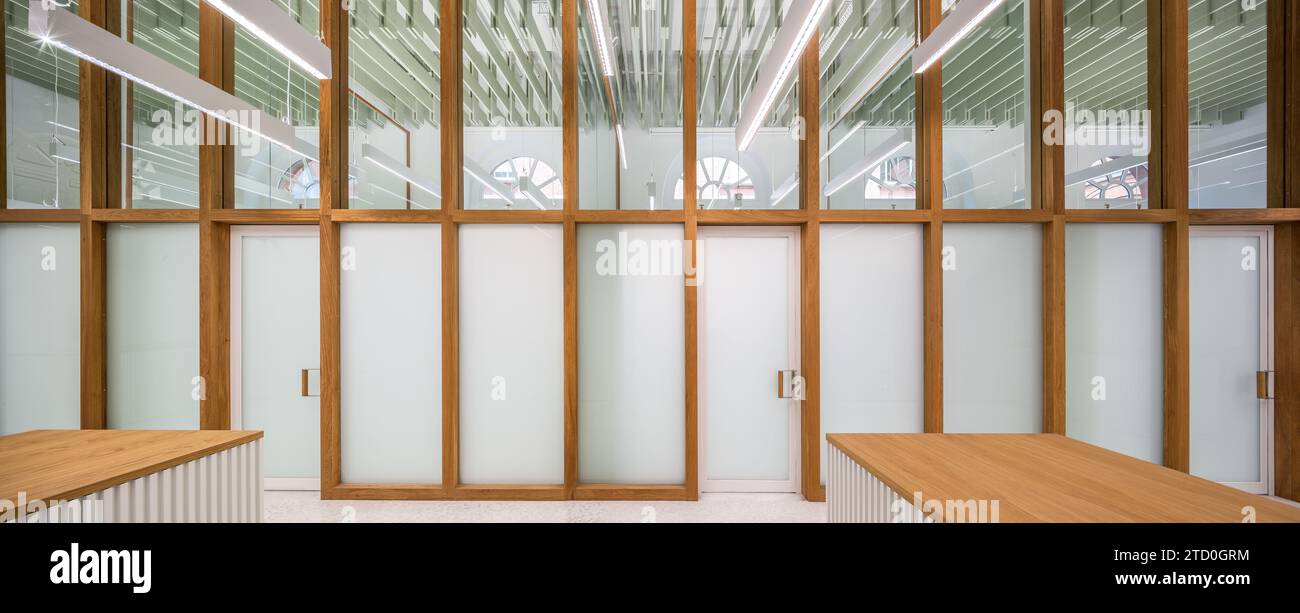 Illuminated interior of contemporary library with glass and wooden ...
